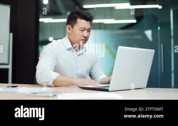 Asian business Man employee with a heart attack office worker with severe heart pain. holding ...