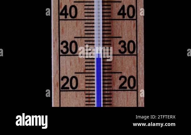 Thermometer showing falling temperature, on a scale followed with ...