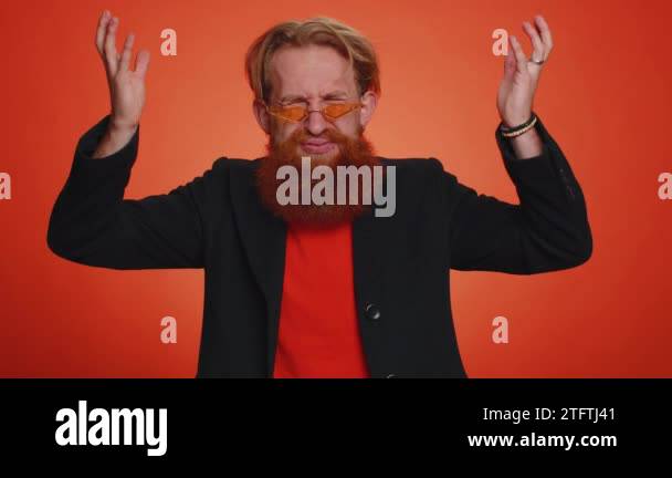 Excited amazed man 20s in jacket touching head and showing explosion ...