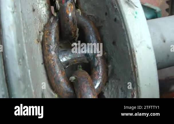 Anchor chain moving through the shaft of a ships winch Stock Video ...