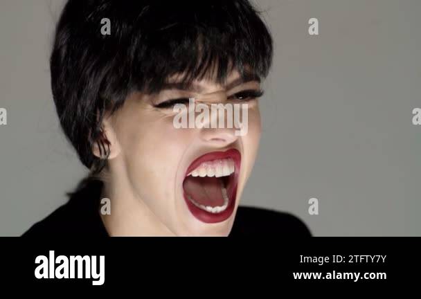 Screaming face close up. Hate and rage. Angry woman screaming ...