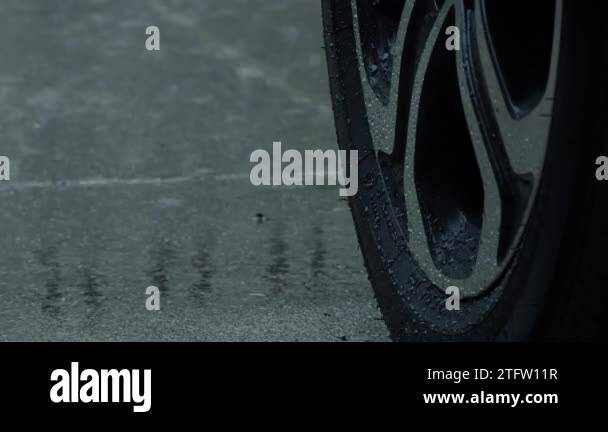 Rain splashing and car tire in rainwater. Car parking in the rain ...