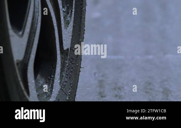 Rain splashing and car tire in rainwater. Car parking in the rain ...