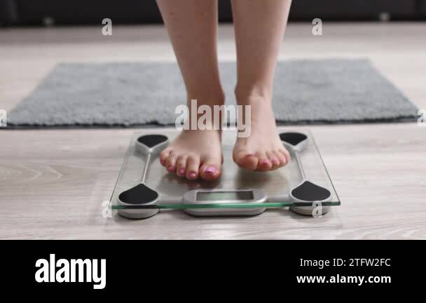 Girl Legs Step On Bathroom Scale. Woman On Scales Measure Weight. Human ...