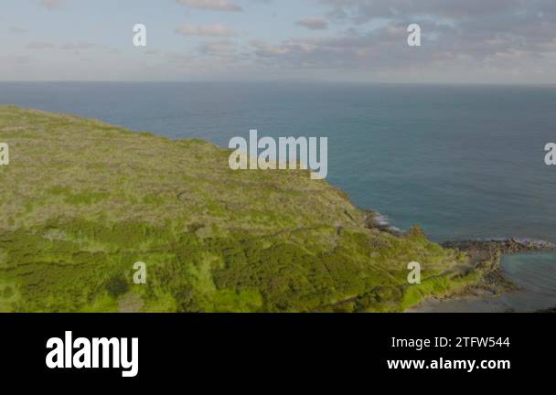 Push forward over ridge on island of Oahu near Sandy Beach park and out ...