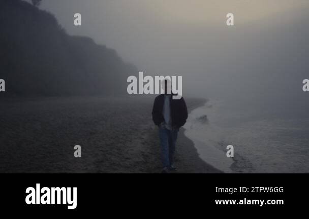 Sad man walking sea shore. Upset guy feeling lonely. Model looking ...