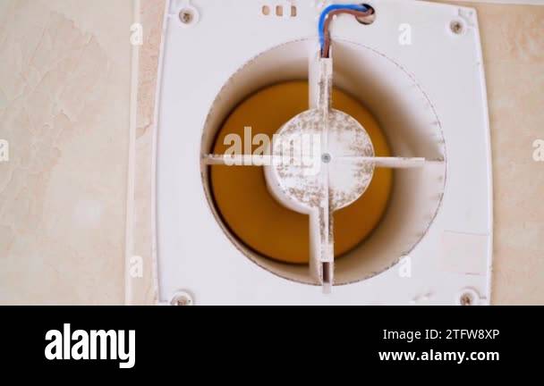 Rotation of the yellow fan of the air extract built into the wall close ... Rotation of the yellow fan of the air extract built into the wall close ...