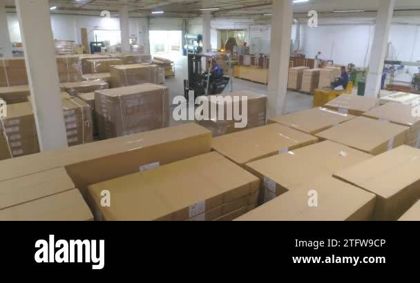 Warehouse with boxes in a factory. A forklift in a large warehouse ...