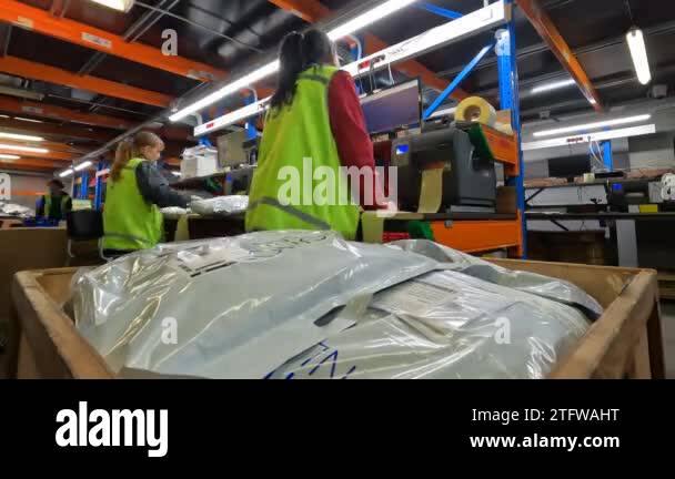 Packing goods in boxes. Preparing goods for shipment. Logistics center ...
