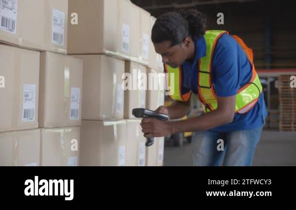 Young man scanning barcode to package box with transportation and ...