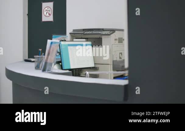 Hospital reception counter with medical appointments on computer to ...