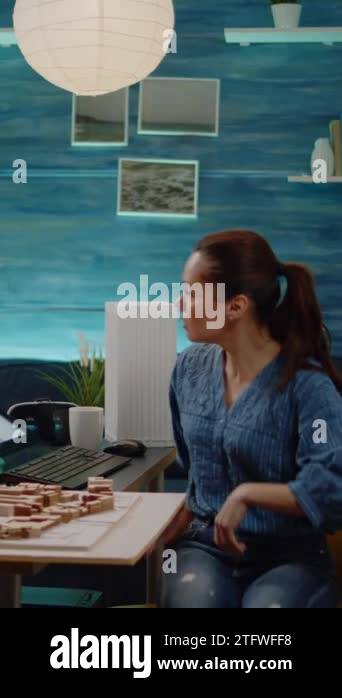 Vertical video: Woman architect designing layout for building on ...