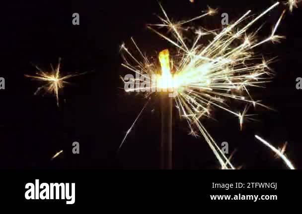 Ignition and burning of sparklers on black studio background. Sparkling ...