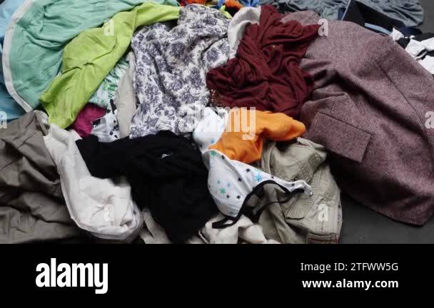 A pile of old used clothes. Fast fashion. Sustainable fashion Stock ...