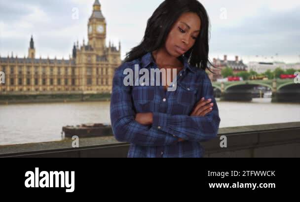 Lonely African-American female stands outside sullenly in London ...