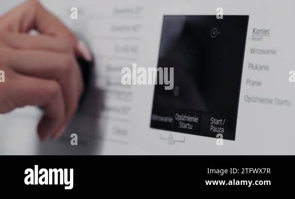 Selective focus on hand selecting laundry settings on state-of-the-art ...