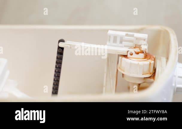 Leaking cracked valve element in the toilet cistern. The problem of overflowing water in the ...