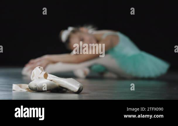 Unfocused blurry girl artist dancer tired child ballerina sitting on ...