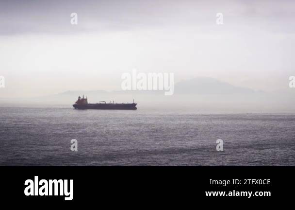 Iconic cinematic shot of huge cargo vessel sailing in mediterranean sea ...