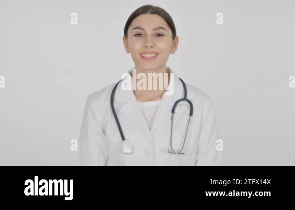 Spanish Female Doctor Shaking Head in Approval on White Background ...