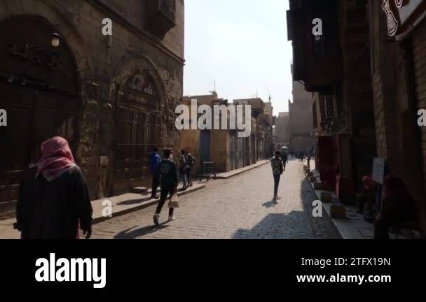 Egyptian people walking in pedestrian street of old Cairo historic town ...