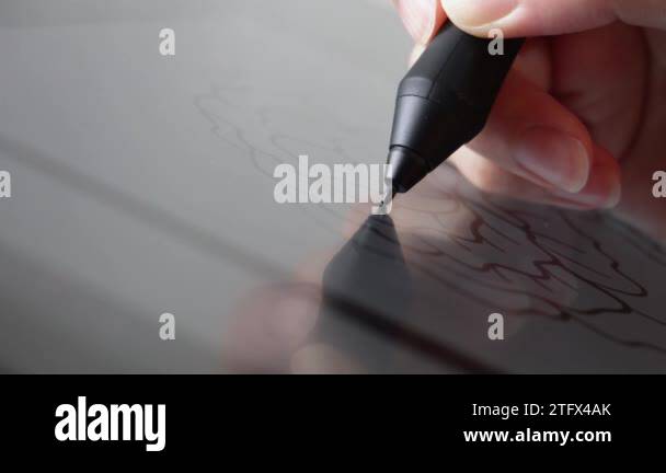 Woman's hand holding a pen stylus making an illustration using a ...