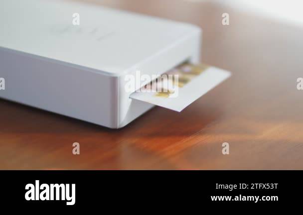 The mini printer prints out a photo of a small child. Wireless mini ...