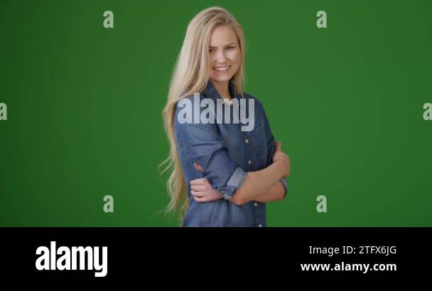Attractive blond female smiling on green screen. On green screen to be ...