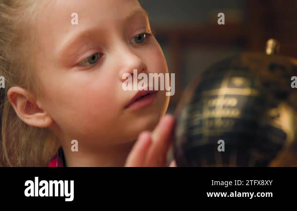 School girl pupil junior kid child traveler toddler look at globe ...