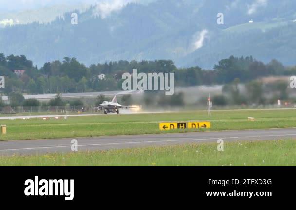 Scenic vintage fighter jet airplane take off from wet runway in 4K ...