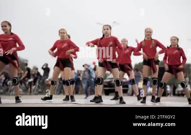 Young girls dancers dance in a public place. Street dancers show a ...