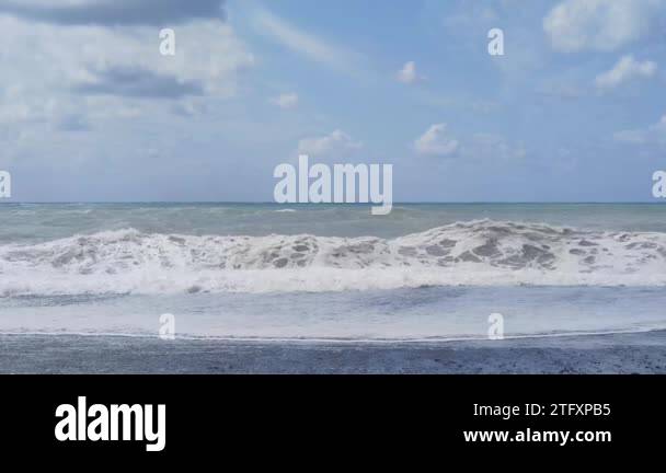Wave breaking slow motion on rocks. Waves of river and sea water meet ...