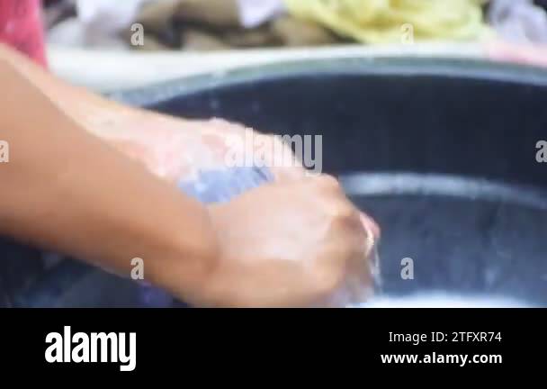 Asian woman washing clothes. washing and scrubbing clothes close up HD ...