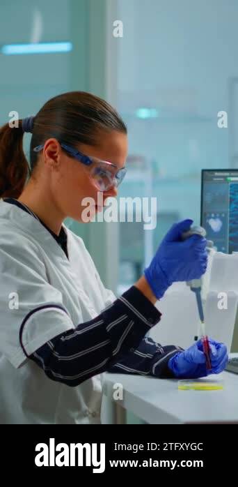 Vertical video: Scientist in modern equipped medical laboratory ...