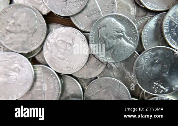 4K HD video zooming in on two coins in the middle of a pile of Nickels ...