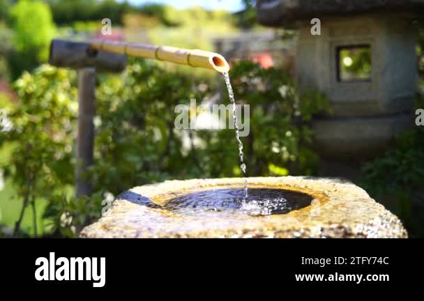Water flowing of bamboo in traditional Japanese garden. nature ...