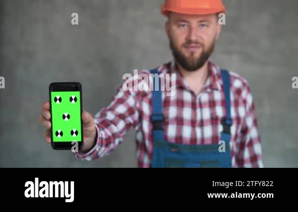 Building services. Male construction worker demonstrating blank ...