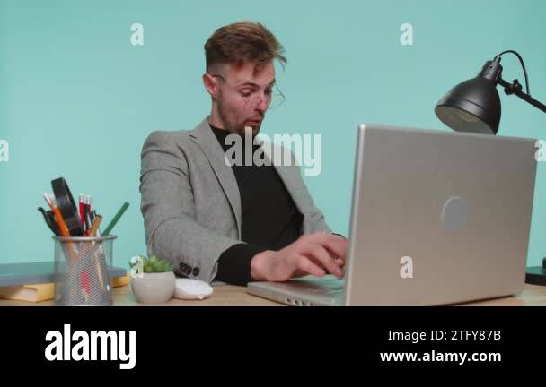 Planning budget. Rich happy bearded business man sitting at office desk ...