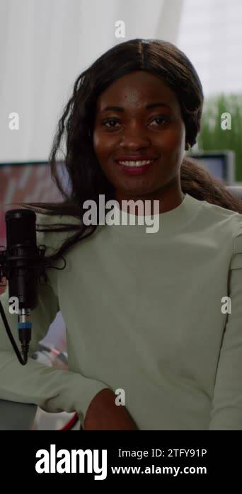 Vertical video: Portrait of excited african professional streamer ...