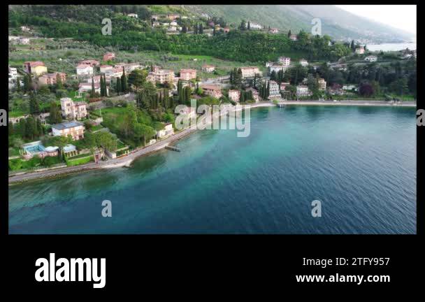 Drone stationary above the beautiful city of Malcesine,Italy with ...