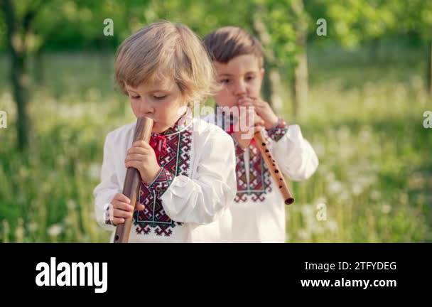 Little brothers boys playing on woodwind wooden flute - ukrainian ...