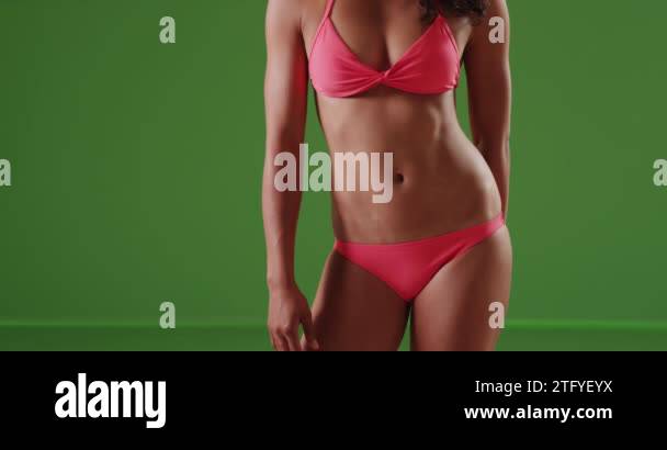 Young Filipino Woman Standing In Swimsuit On Green Screen On Green