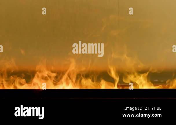 Close-up artificial electric fireplace burning with smoke fire. Bio ...