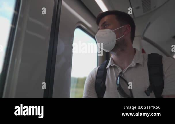 Crowded train at 9 euro ticket in Germany. Male passenger wearing mask ...