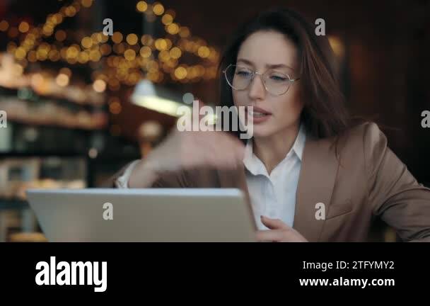 Angry business woman sitting at cafe table and having serious ...