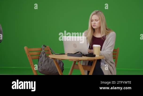 Intelligent school girl studying on laptop computer on green screen. On ...