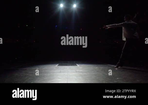 Dancers couple come out of darkness on stage,silhouettes against dark ...