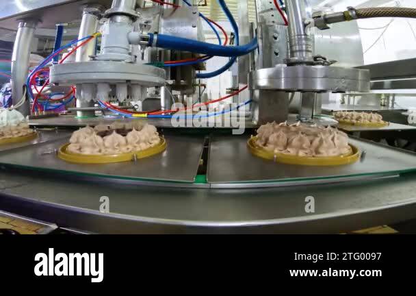 The process of creating a cake on a conveyor line. Modern confectionery ...
