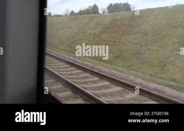 View on railroad track from the window of fast train. 4K Interior view ...