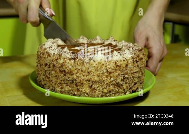 Woman slicing cake. Female hands cut cake slices. Big knife. In the ...